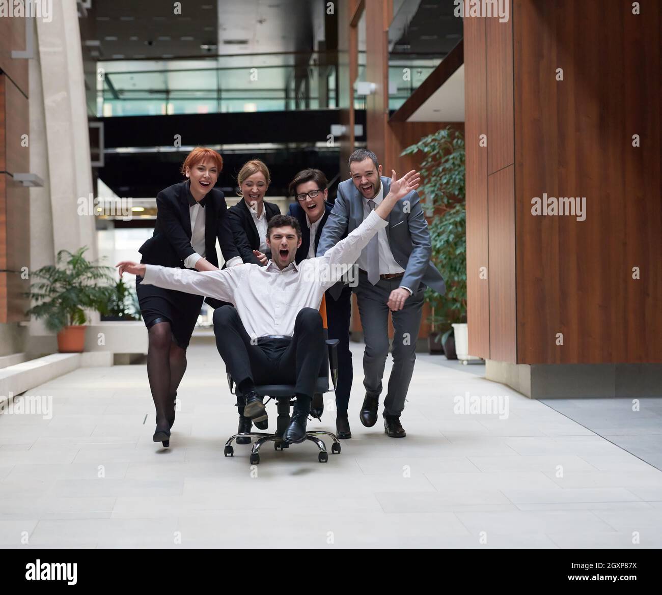 business people group at modern office indoors have fun and push office ...