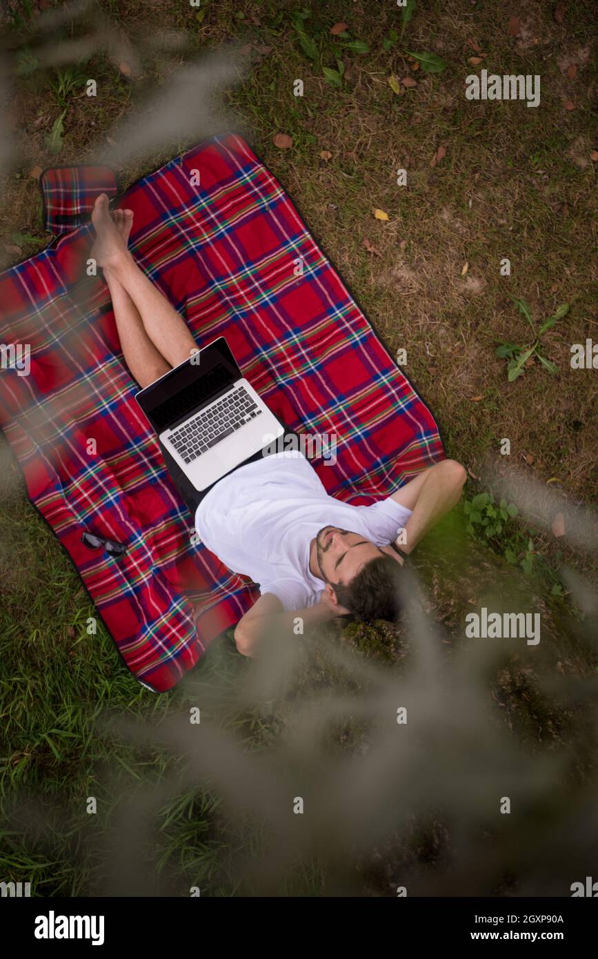 A young freelancer using a laptop computer while working in beautiful ...