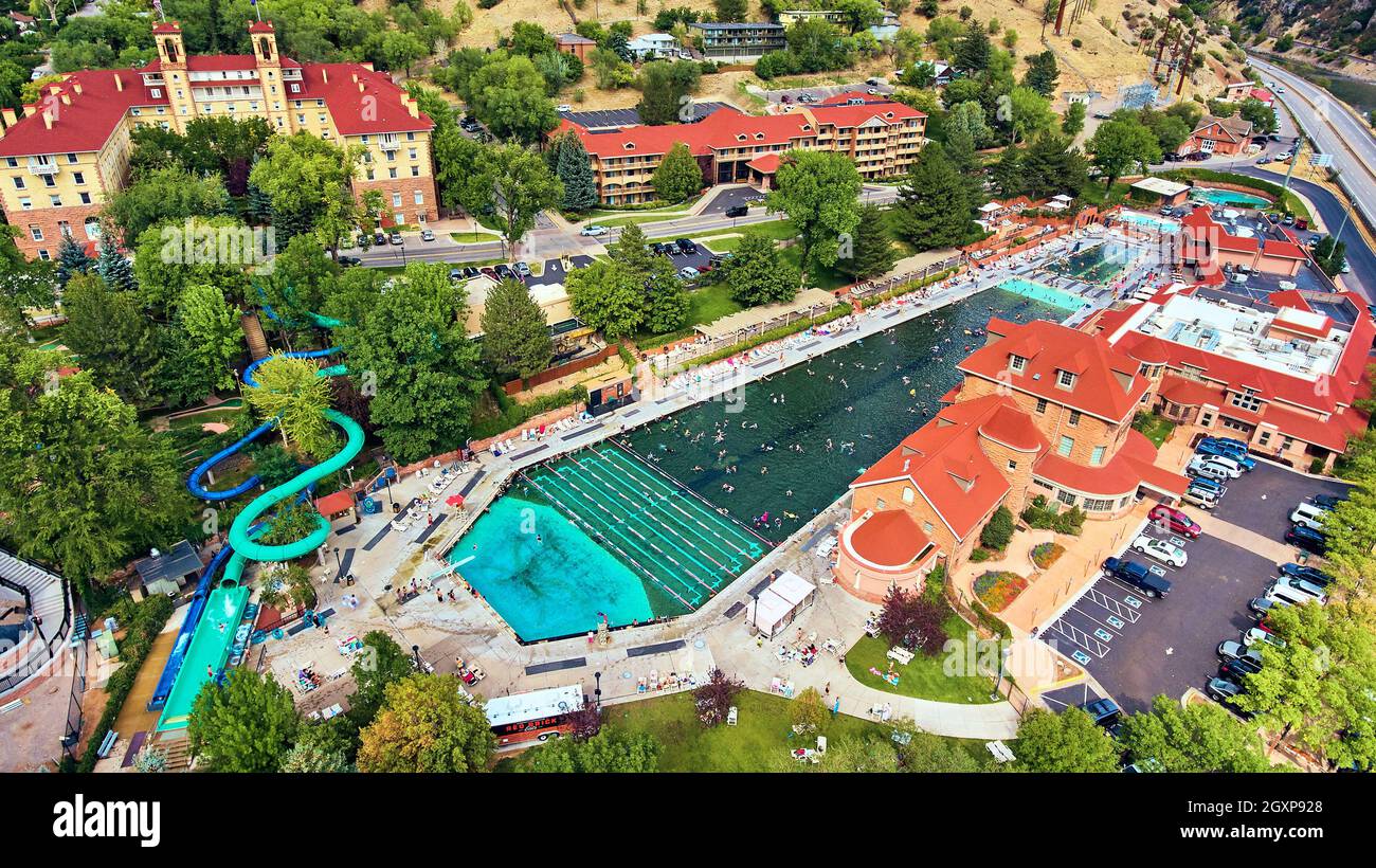 Aerial of beautiful blue natural hot springs attraction in desert town ...