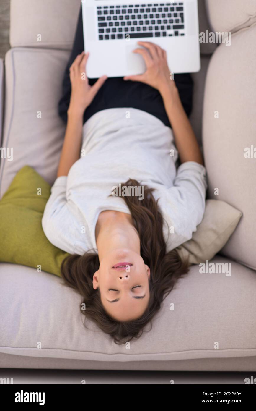 Young woman using her laptop computer in her luxury modern home top ...