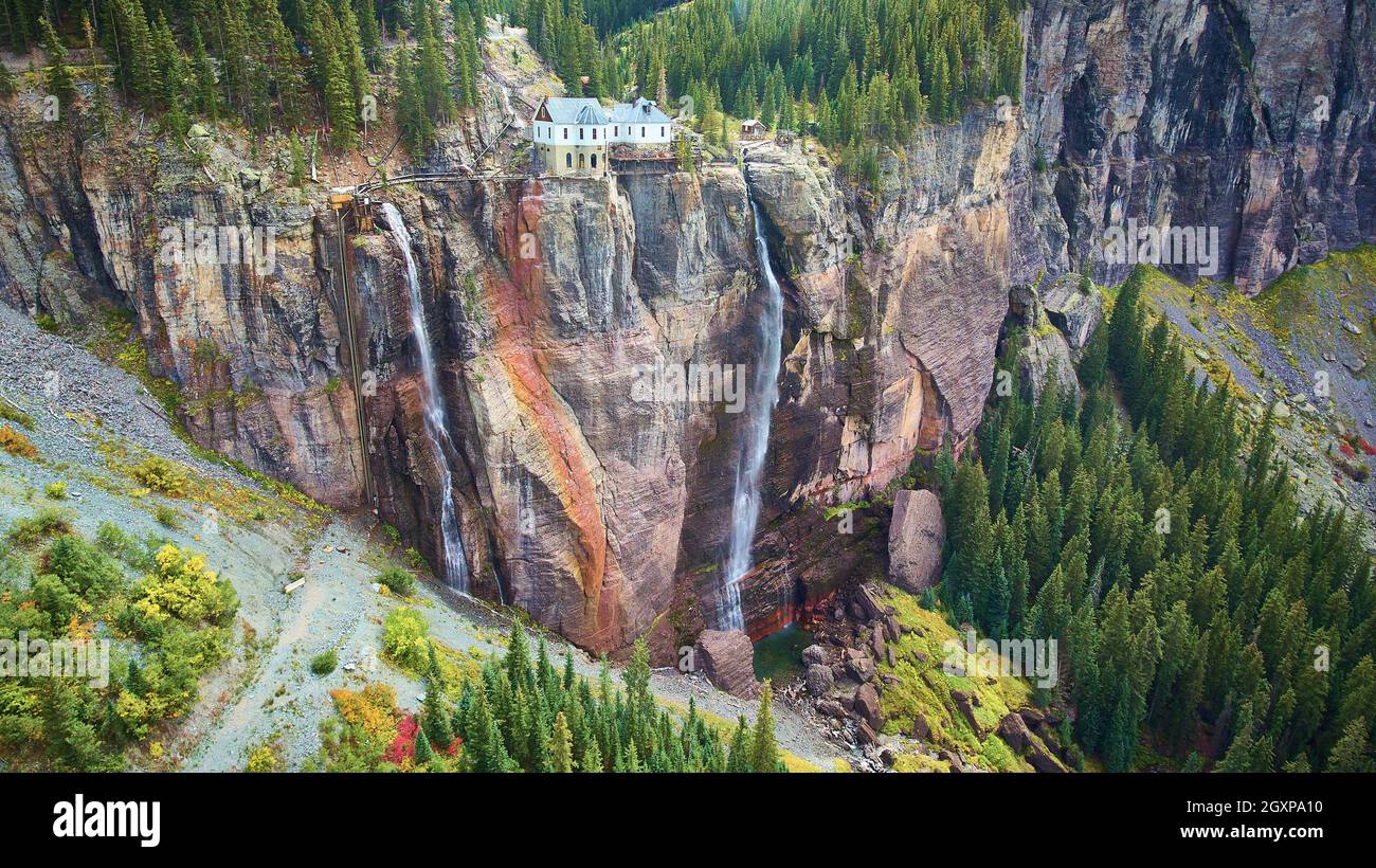 Two waterfalls over giant cliff wall with power station at top Stock ...