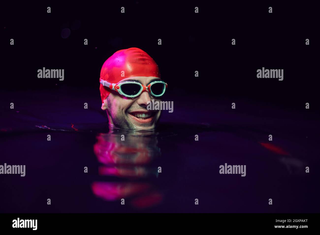 real triathlete swimmer having a break during hard training at lake on ...