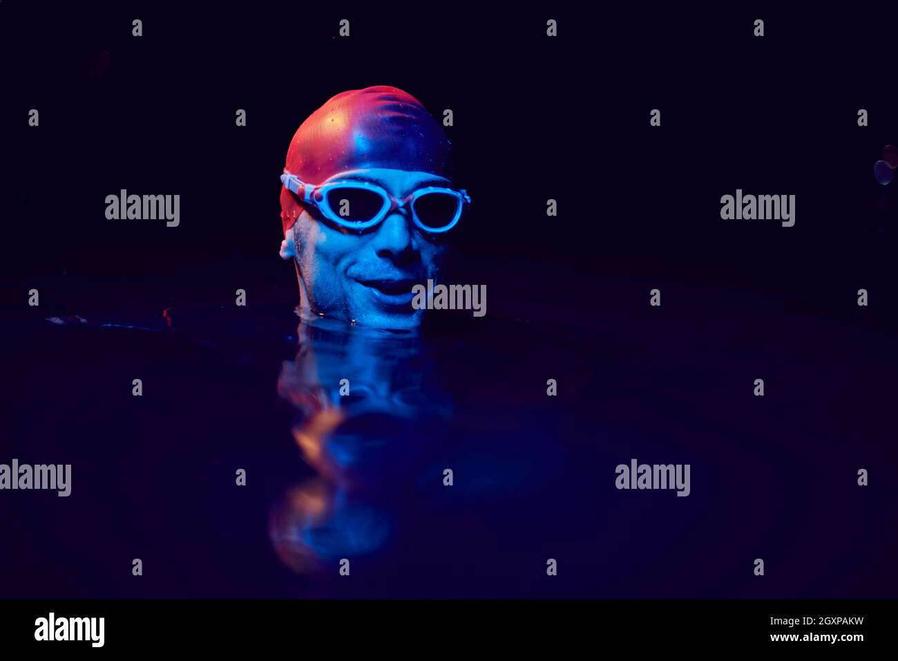 real triathlete swimmer having a break during hard training at lake on ...