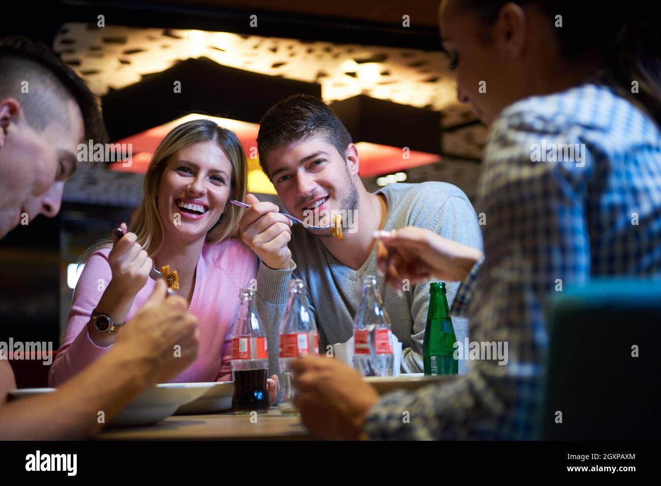 friends have lanch break in shopping mall, eating italian fast food ...