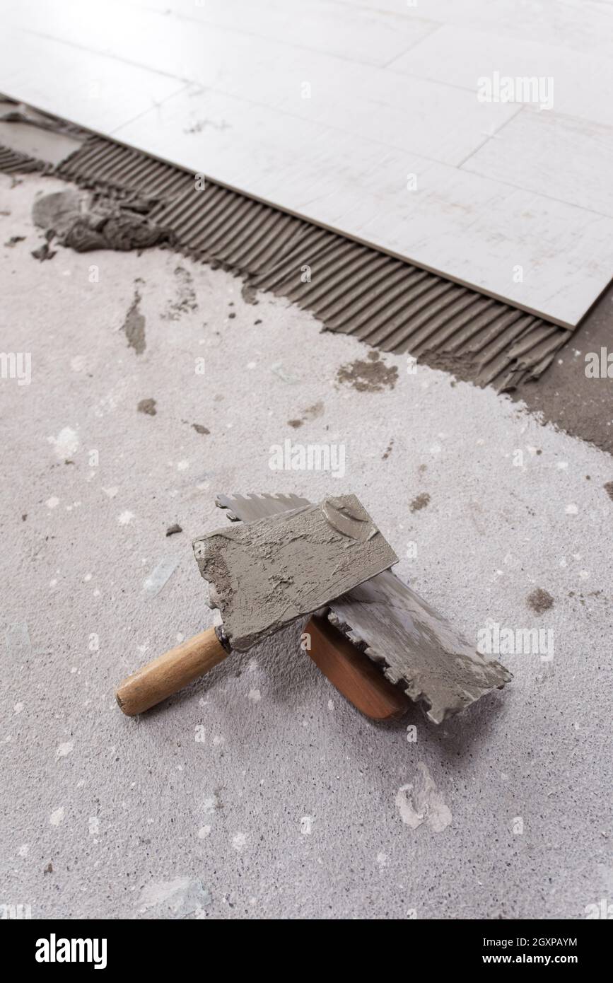 Ceramic wood effect tiles and tools for tiler on the floor unfinished ...