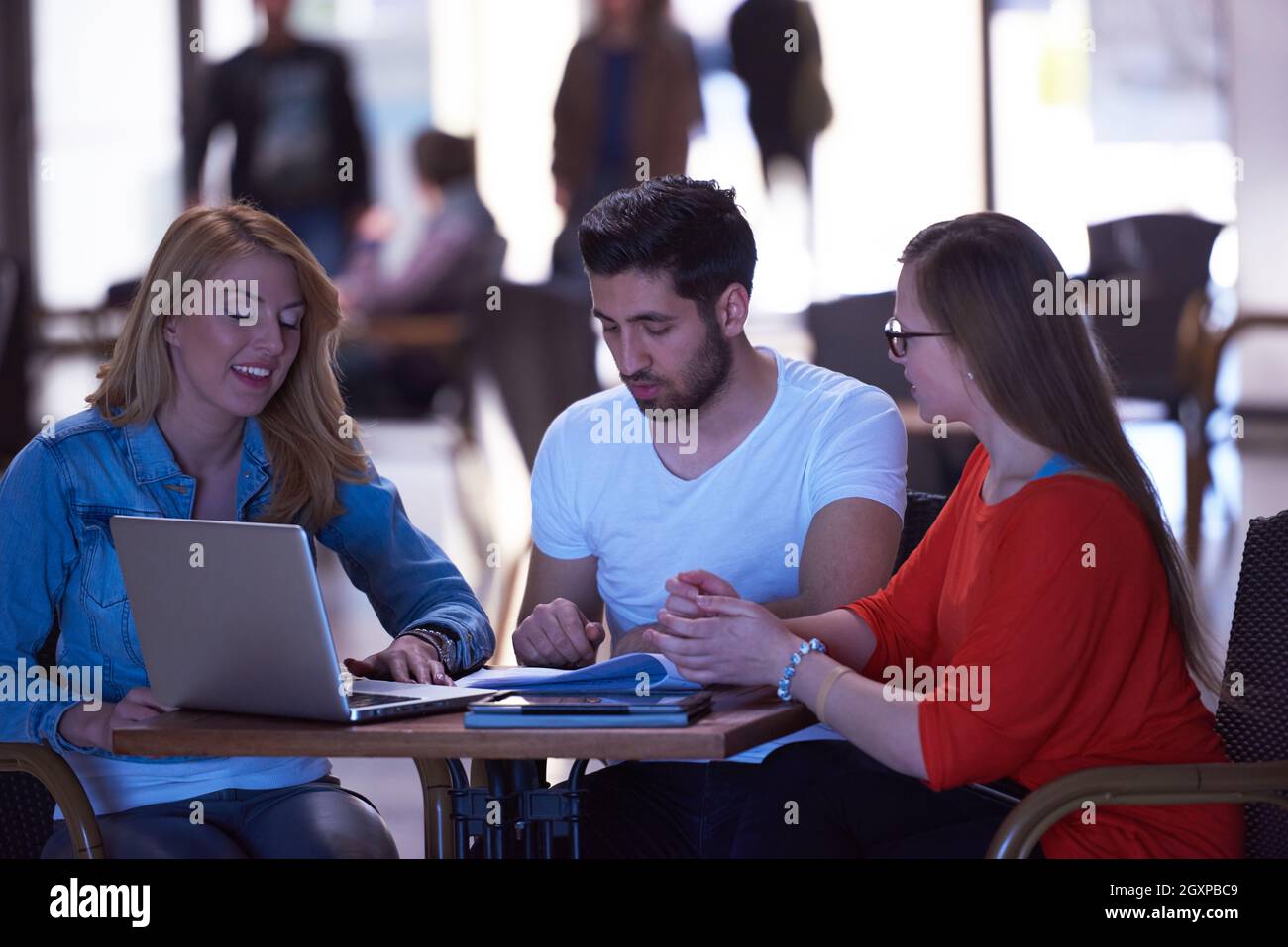 students group working on school project together on tablet computer at ...