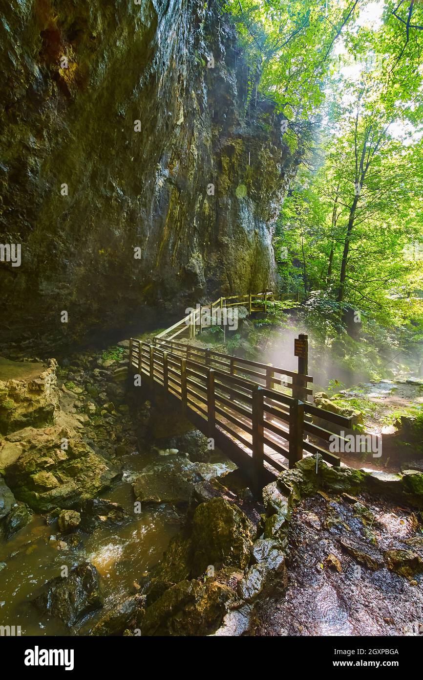 Walking bridge against cliff edge and over creek Stock Photo - Alamy