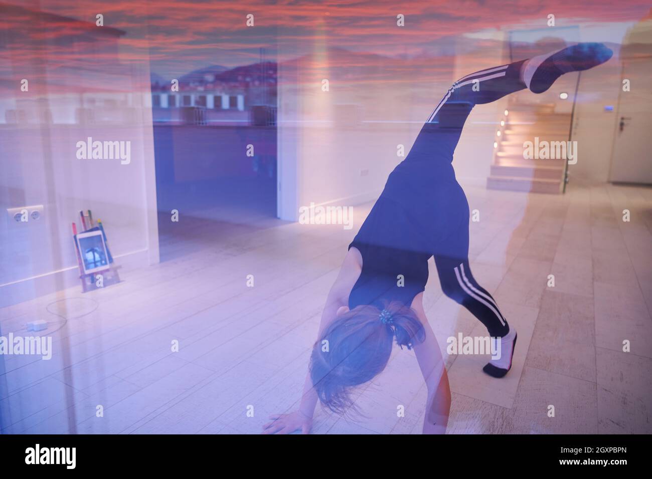 Little girl have online training while watching the tablet and doing ...