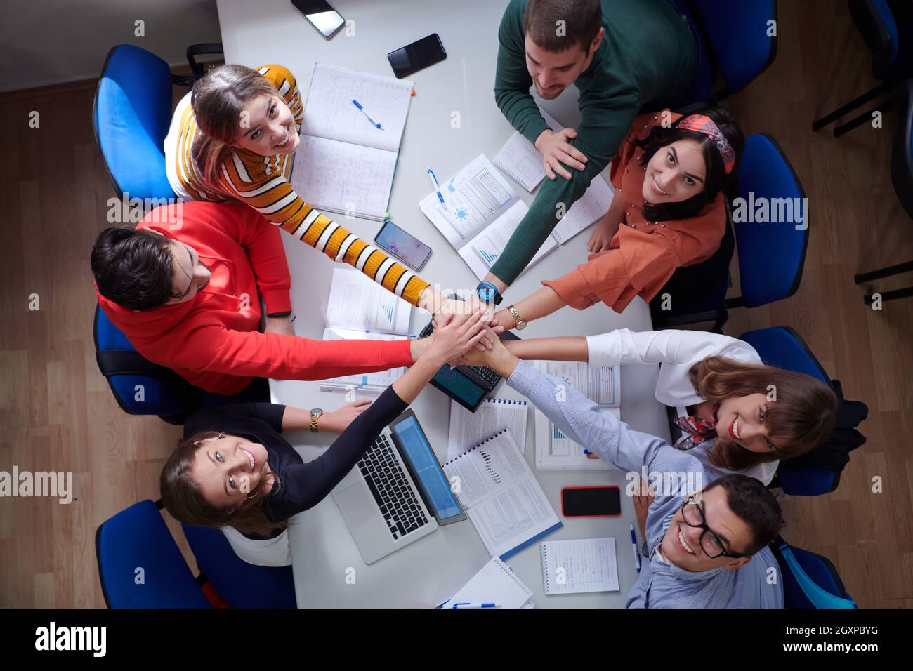 Group of young students in electronics classroom celebrating ...