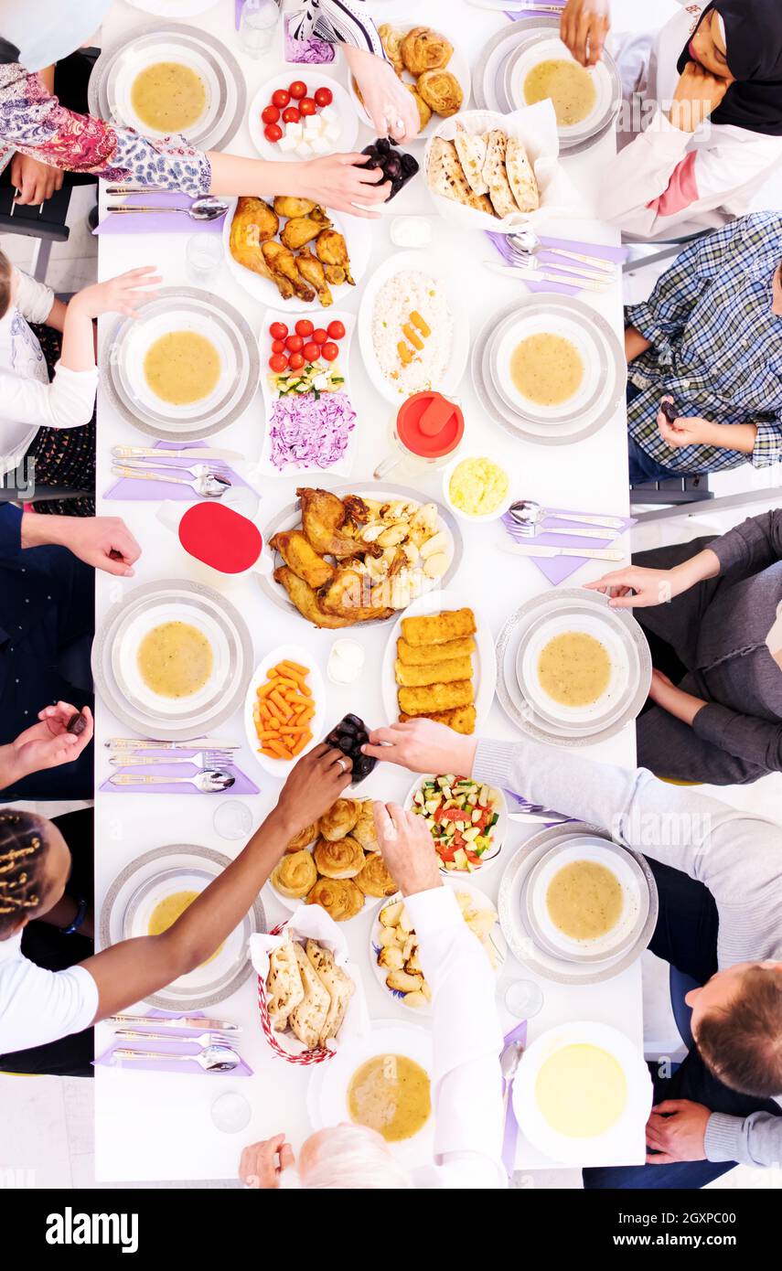 top view of modern multiethnic muslim family enjoying eating iftar ...
