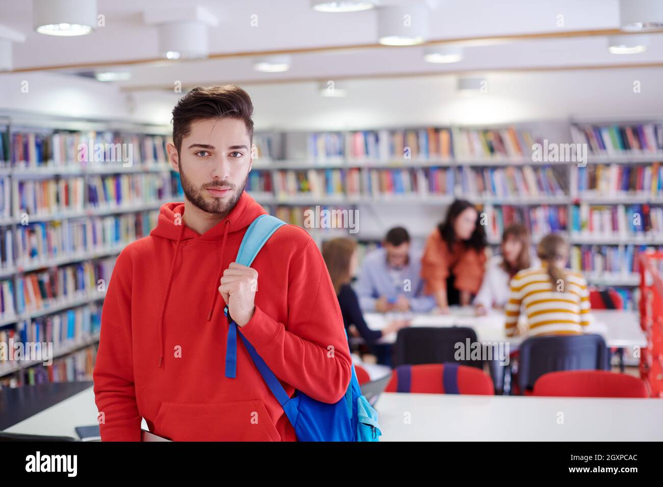 a young student is standing in front of the school library with a ...