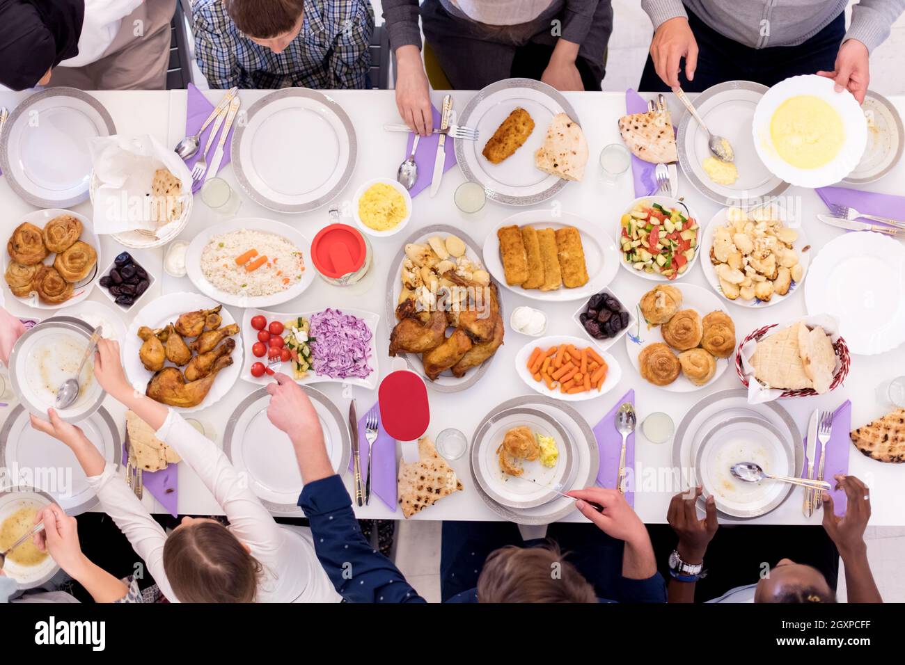 top view of modern multiethnic muslim family enjoying eating iftar ...