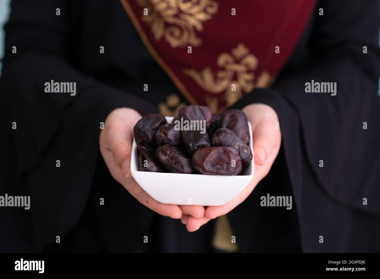 modern muslim woman holding a plate full of sweet dates on iftar time ...