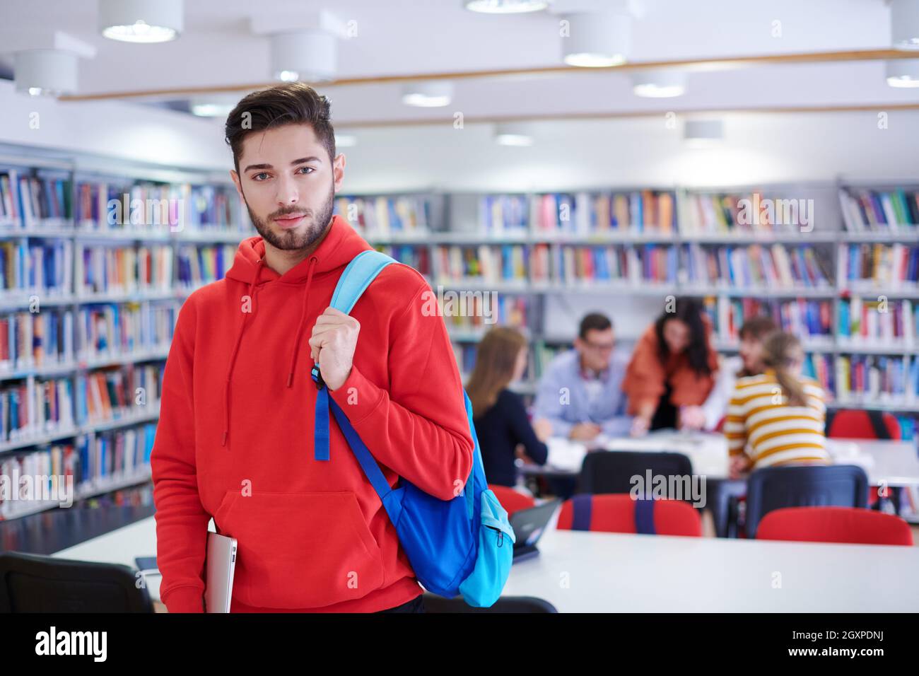 a young student is standing in front of the school library with a ...