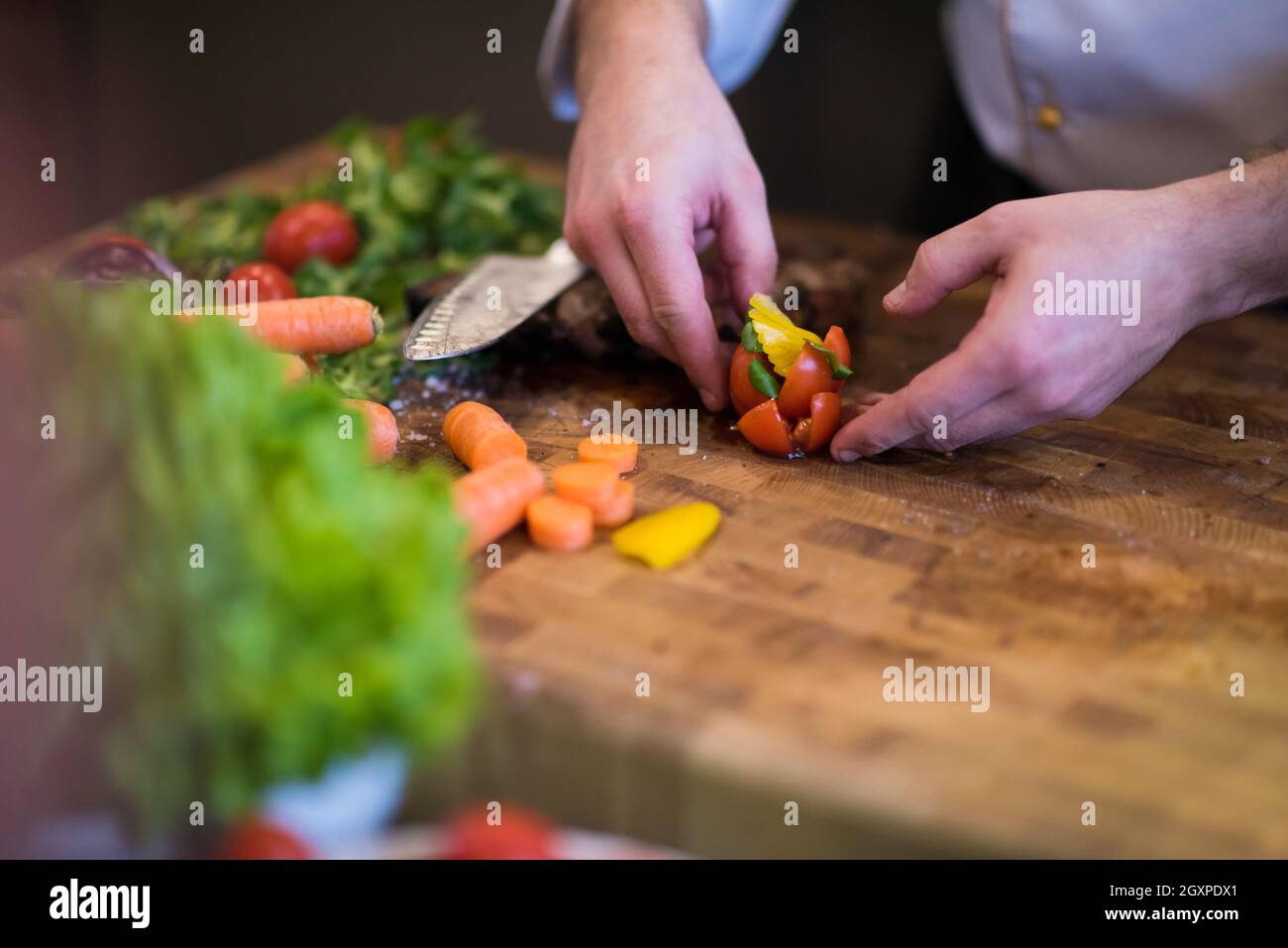 closeup of Chef hands in hotel or restaurant kitchen preparing beef ...