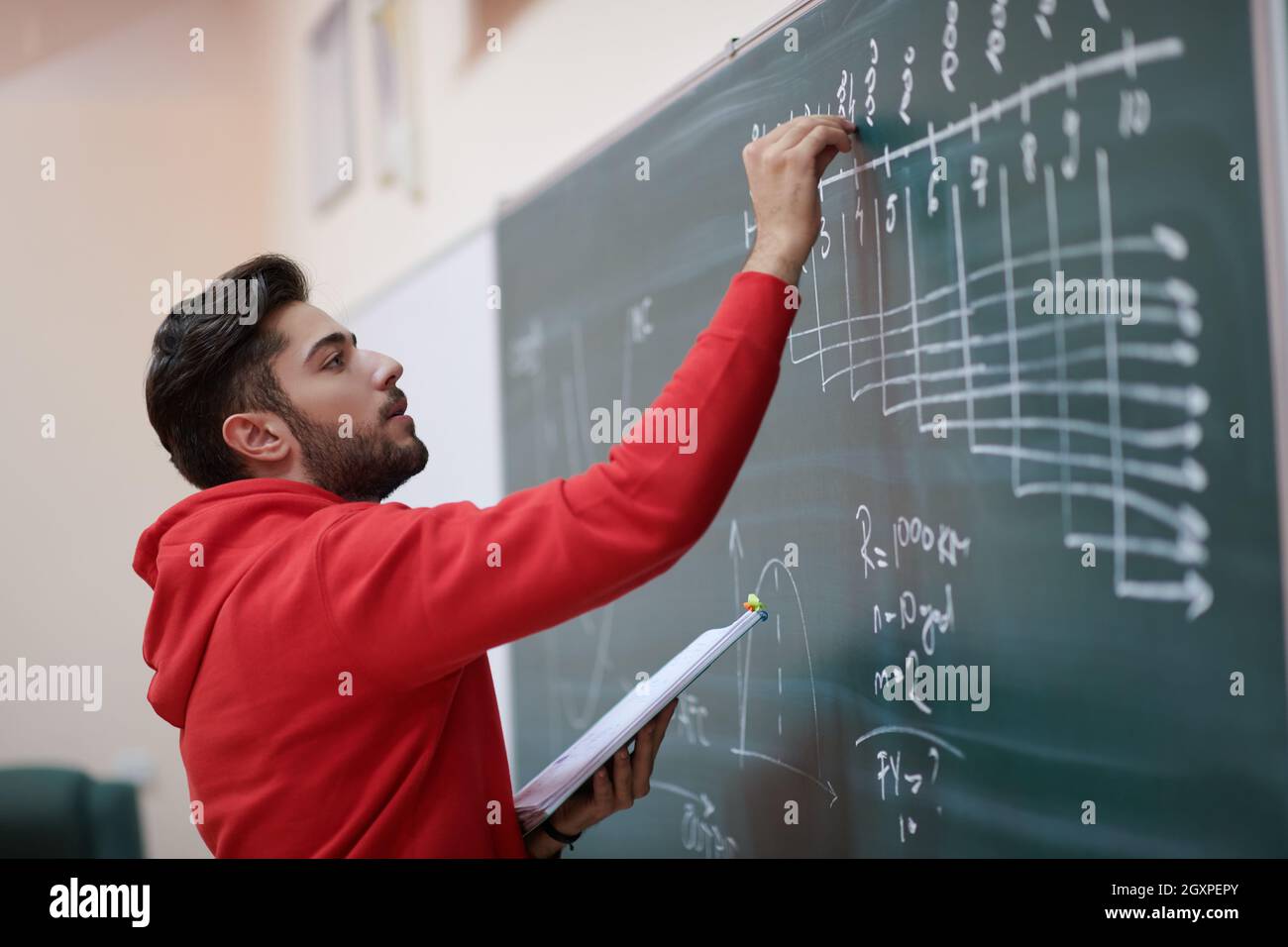 the-student-uses-a-book-trying-to-make-a-math-problem-on-the-board