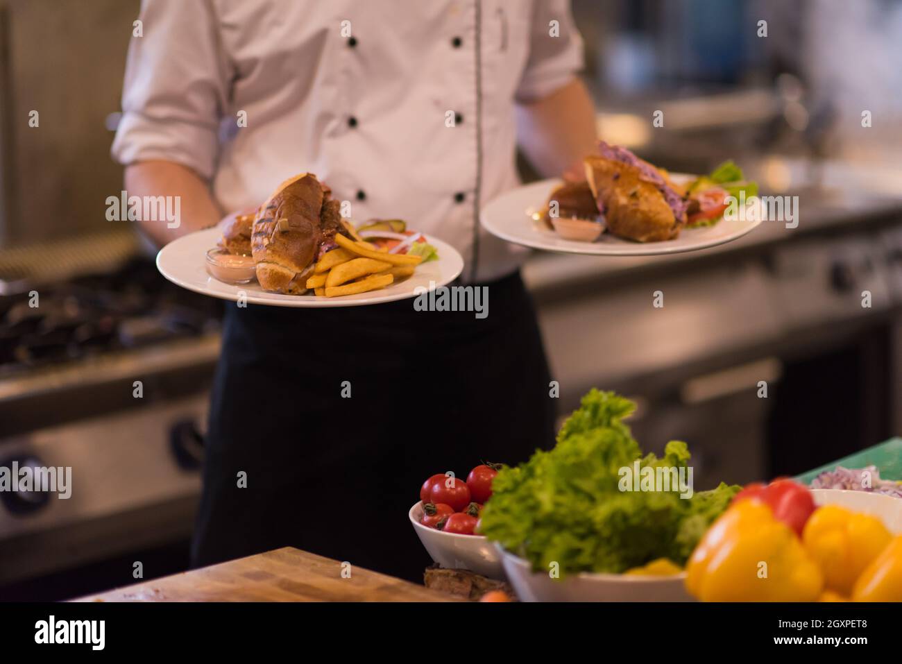 young Chef presenting dishes of tasty meals in commercial kitchen Stock ...