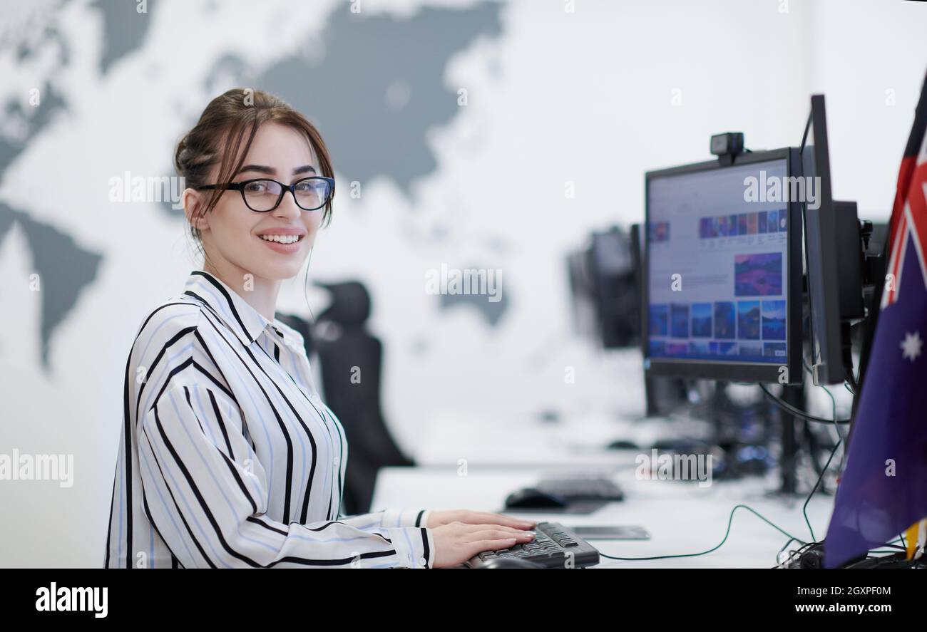 casual business woman working on desktop computer in modern open plan ...