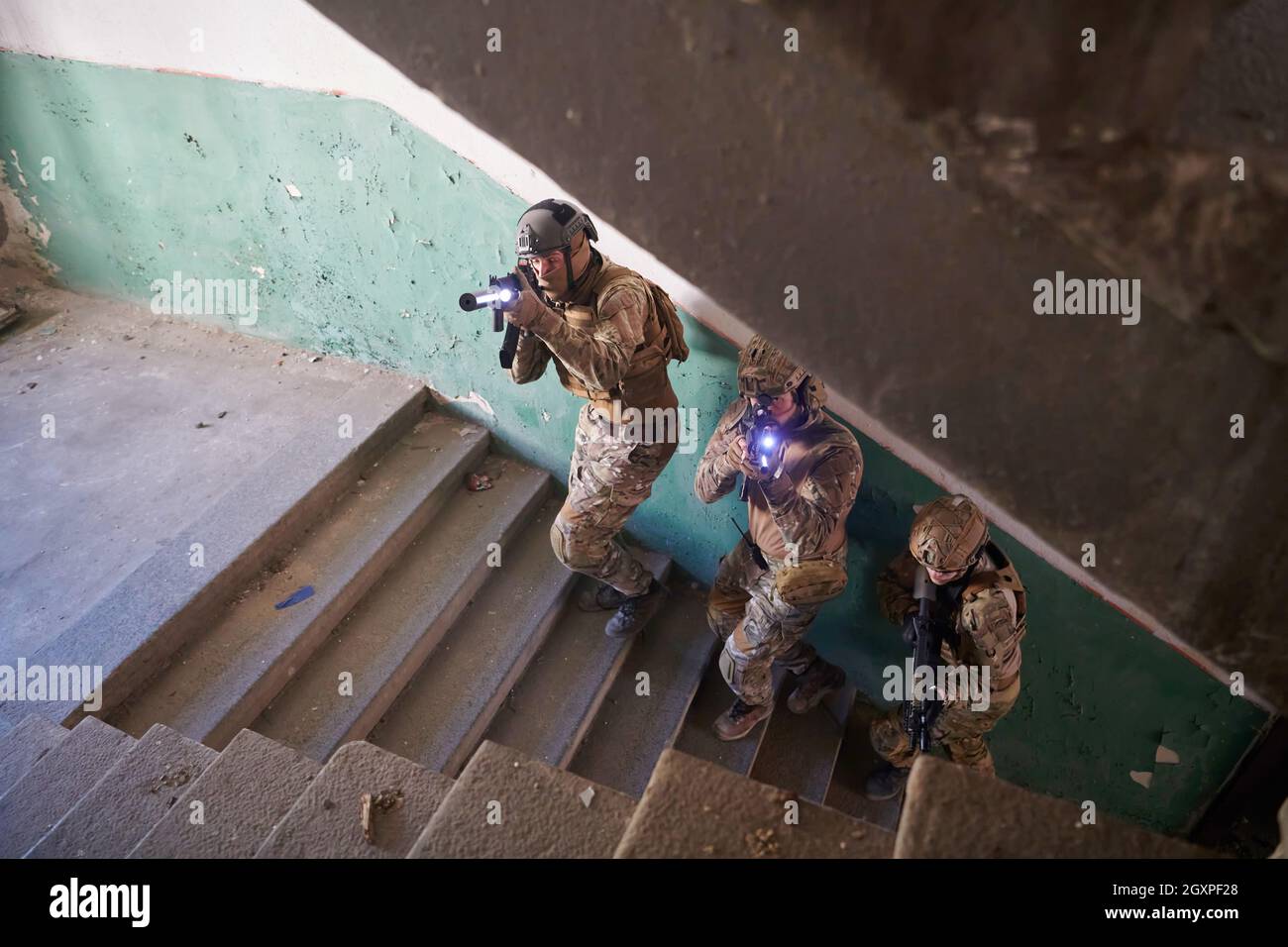 special forces squad team of us marines soldiers ascent stairs in ...