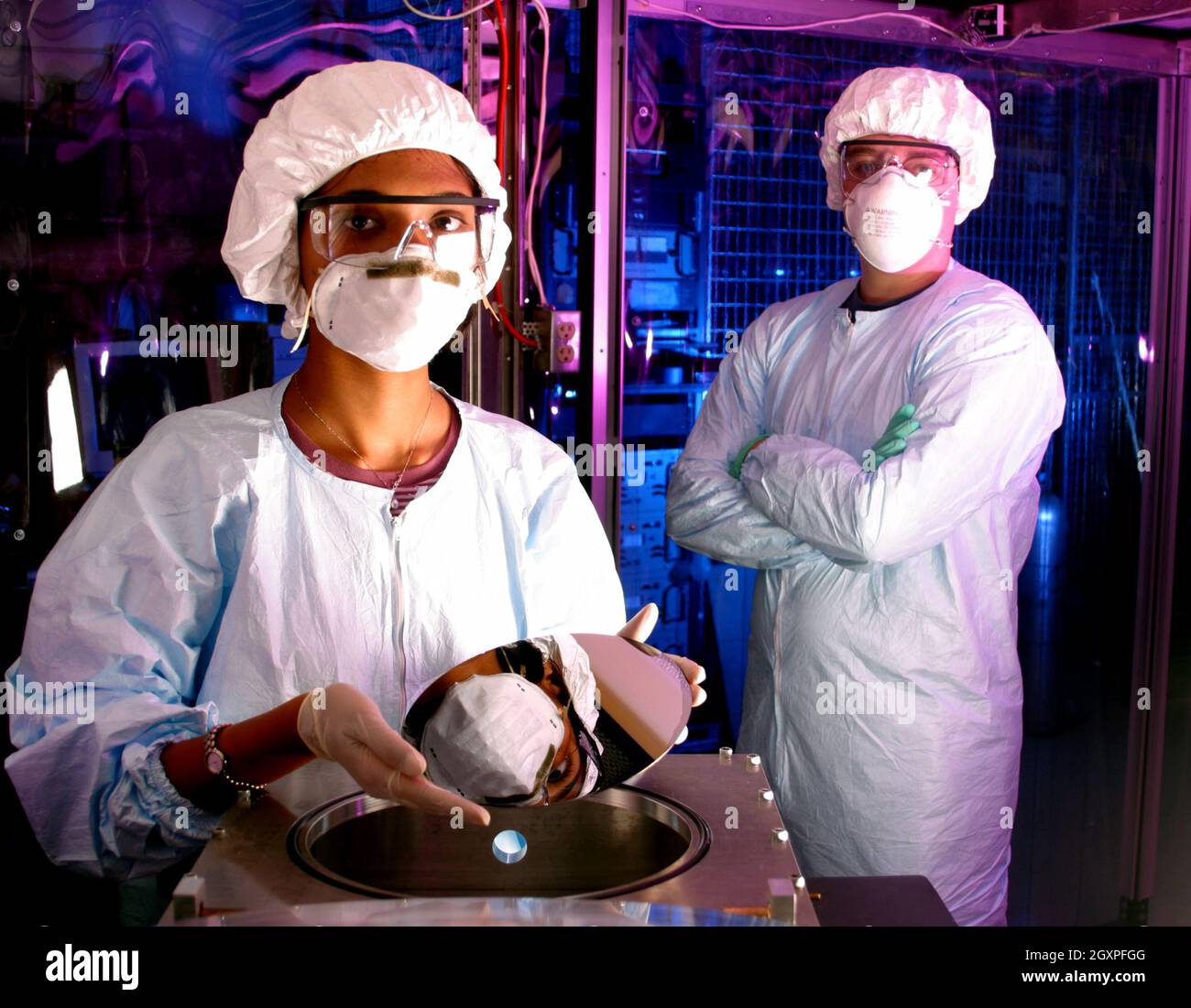 University students conducting research with a silicon wafer in a ...