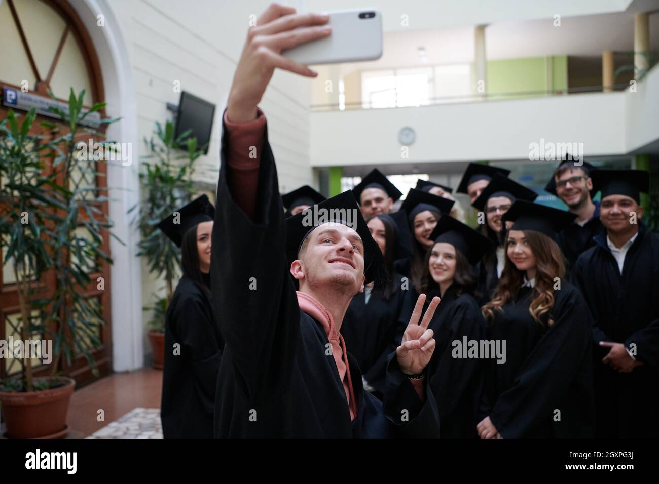 education, graduation, technology and people concept - group of happy ...