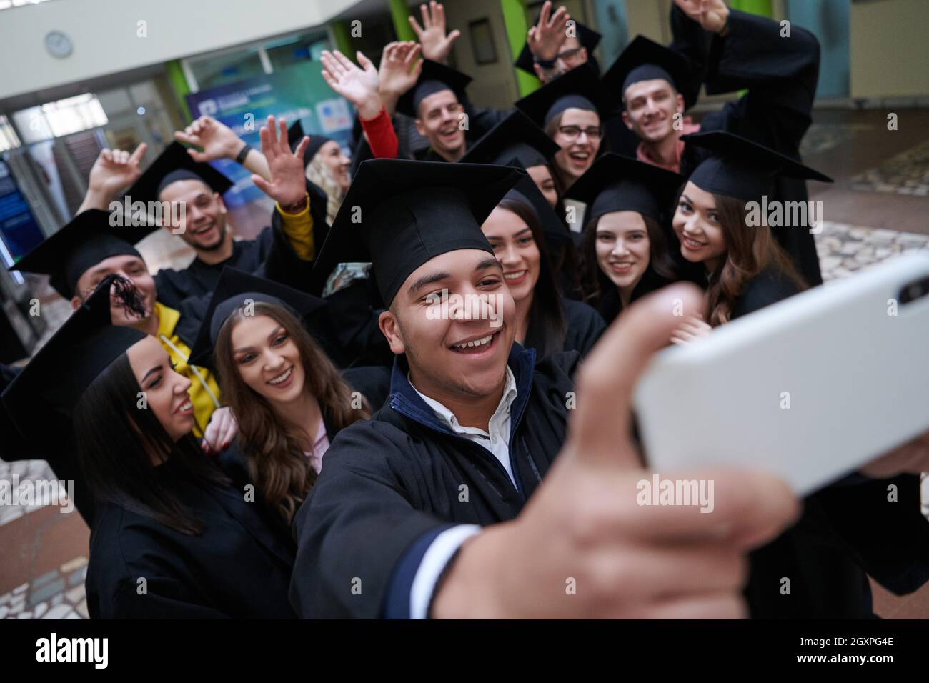 education, graduation, technology and people concept - group of happy ...