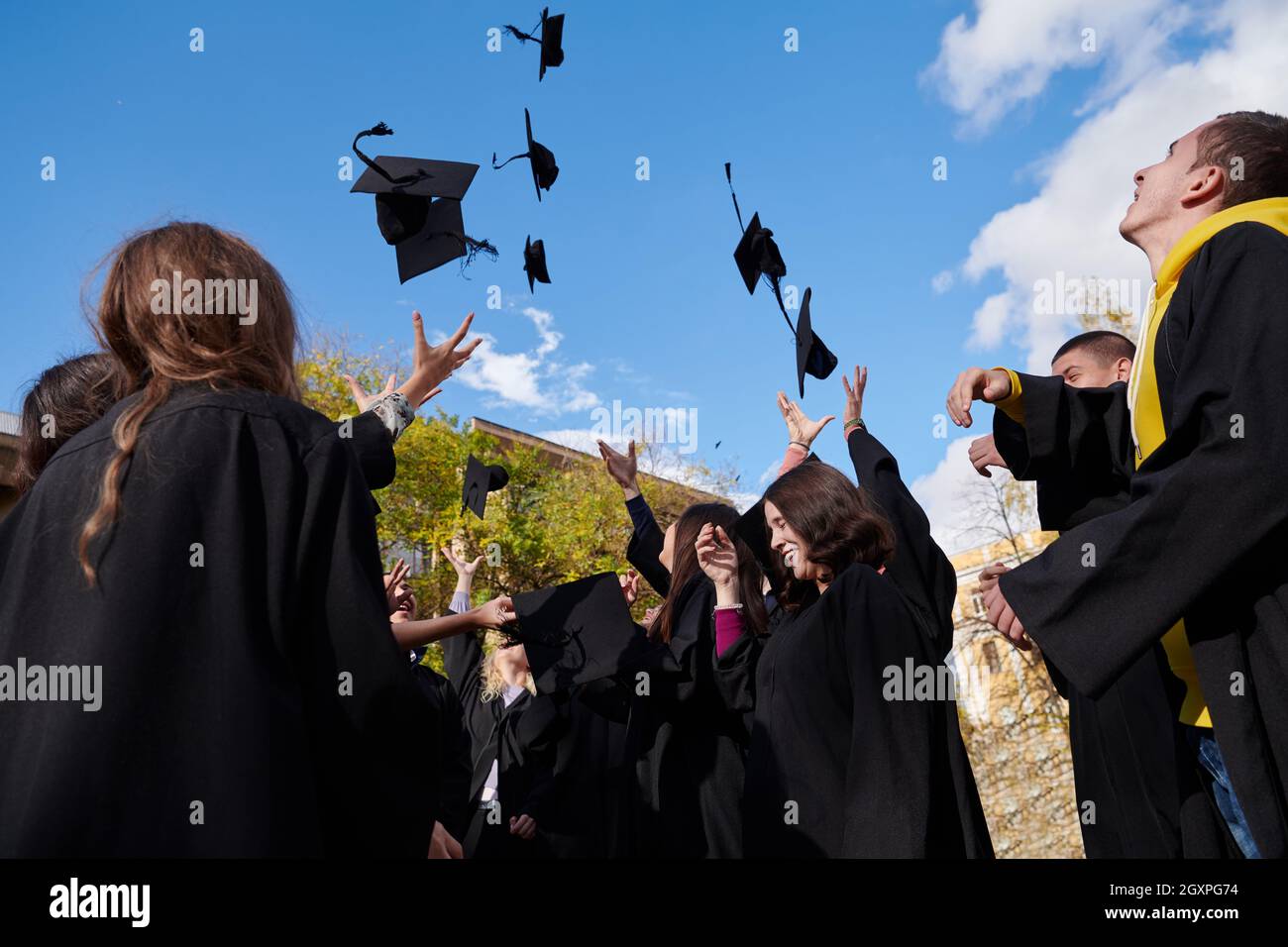 Portrait of young man in graduating cap and gown hi-res stock ...