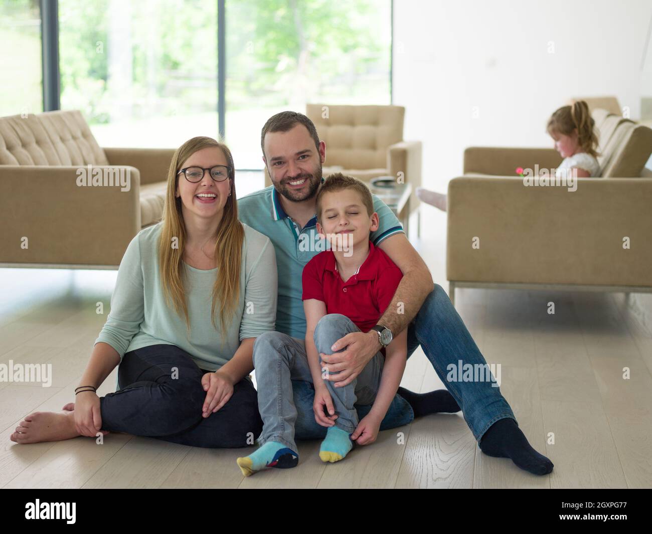 happy young family with little boy enjoys in the modern living room of ...