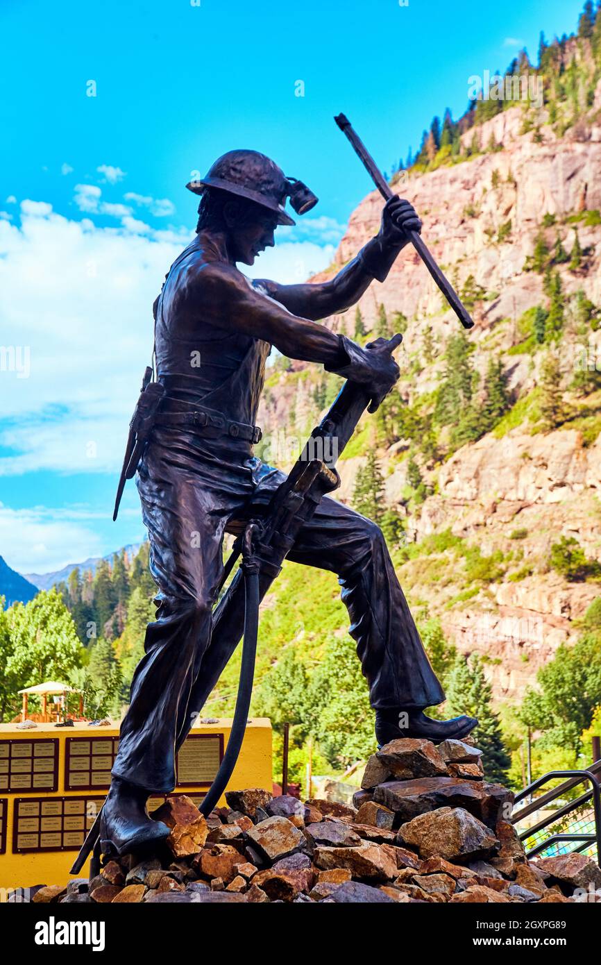 Statue of miner with background of mountains Stock Photo - Alamy