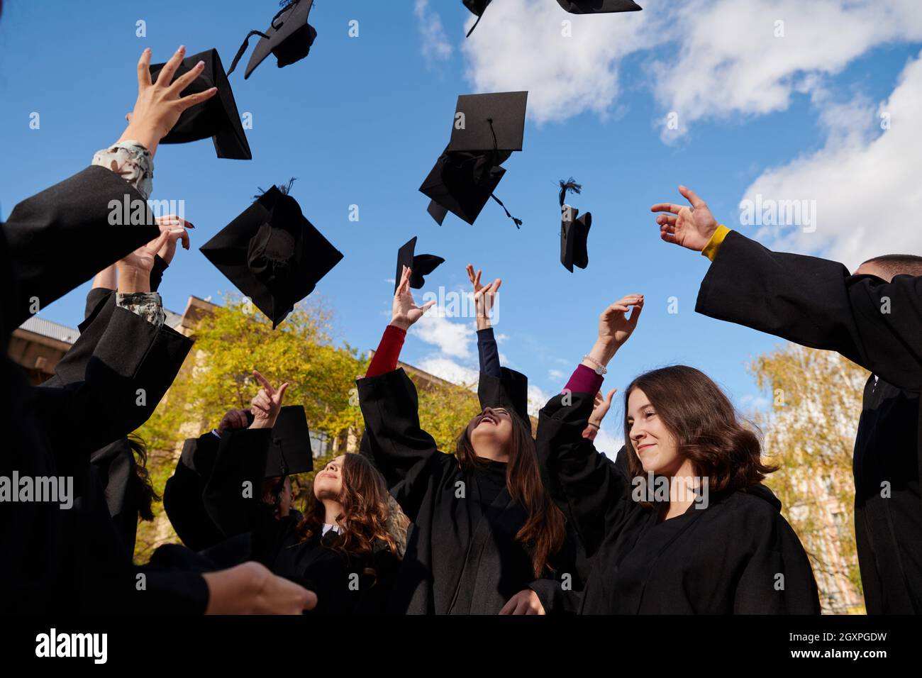 Congratulations! Low angle view of happy group of six young cheerful ...