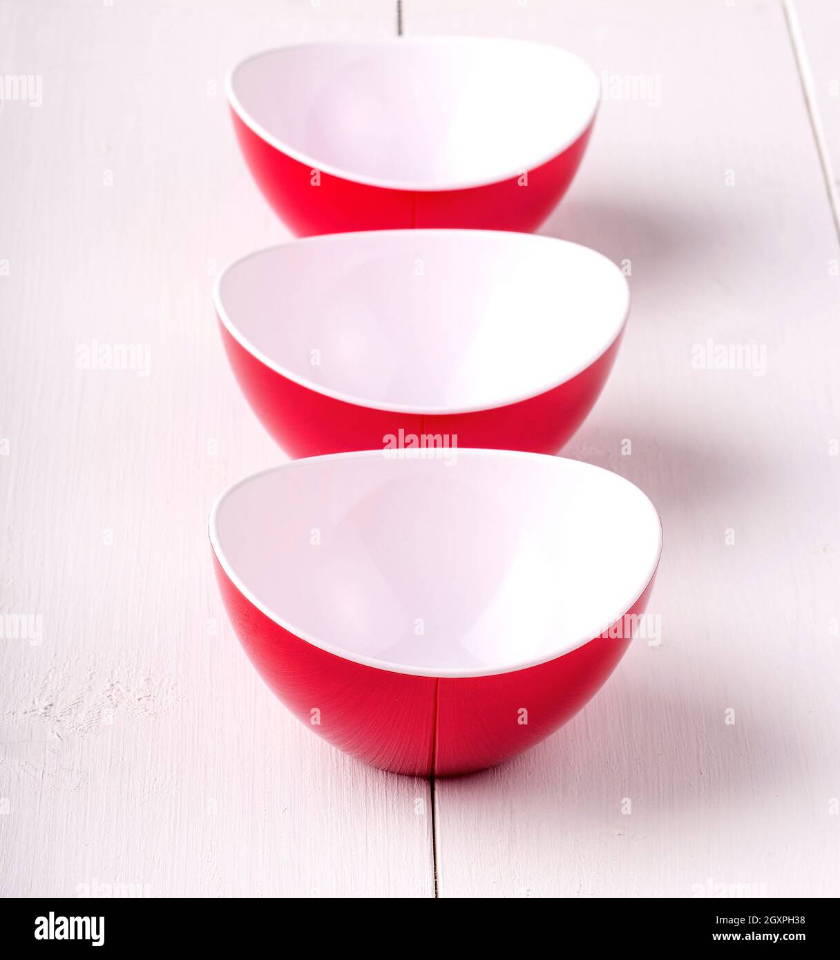 An empty three cups on a white wooden table Stock Photo - Alamy