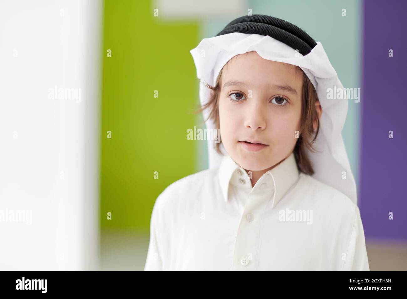 portrait of little arabian boy in traditional clothes during Ramadan ...
