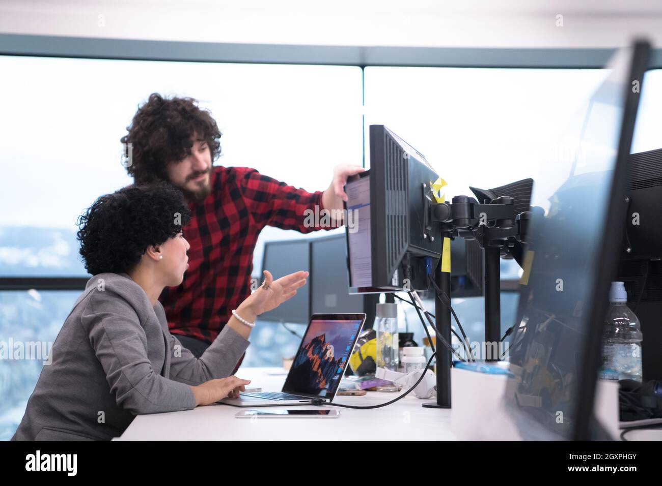 Young Software Developers Couple Using Laptop And Desktop Computer While Writing Programming