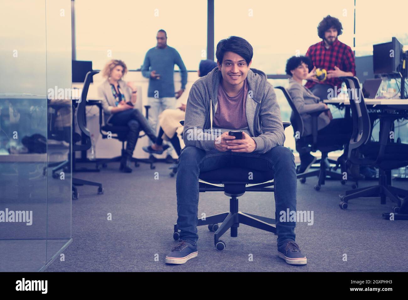 young indian male software developer using mobile phone writing ...