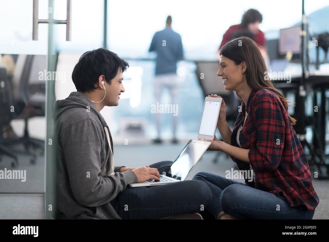 young software developers couple using laptop computer writing ...