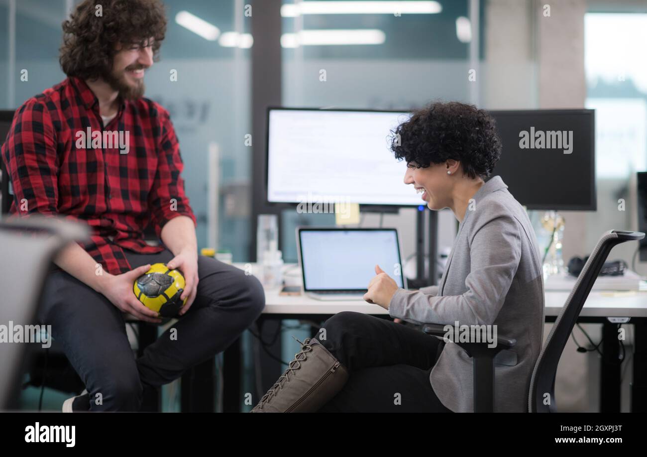 young software developers couple using laptop and desktop computer ...