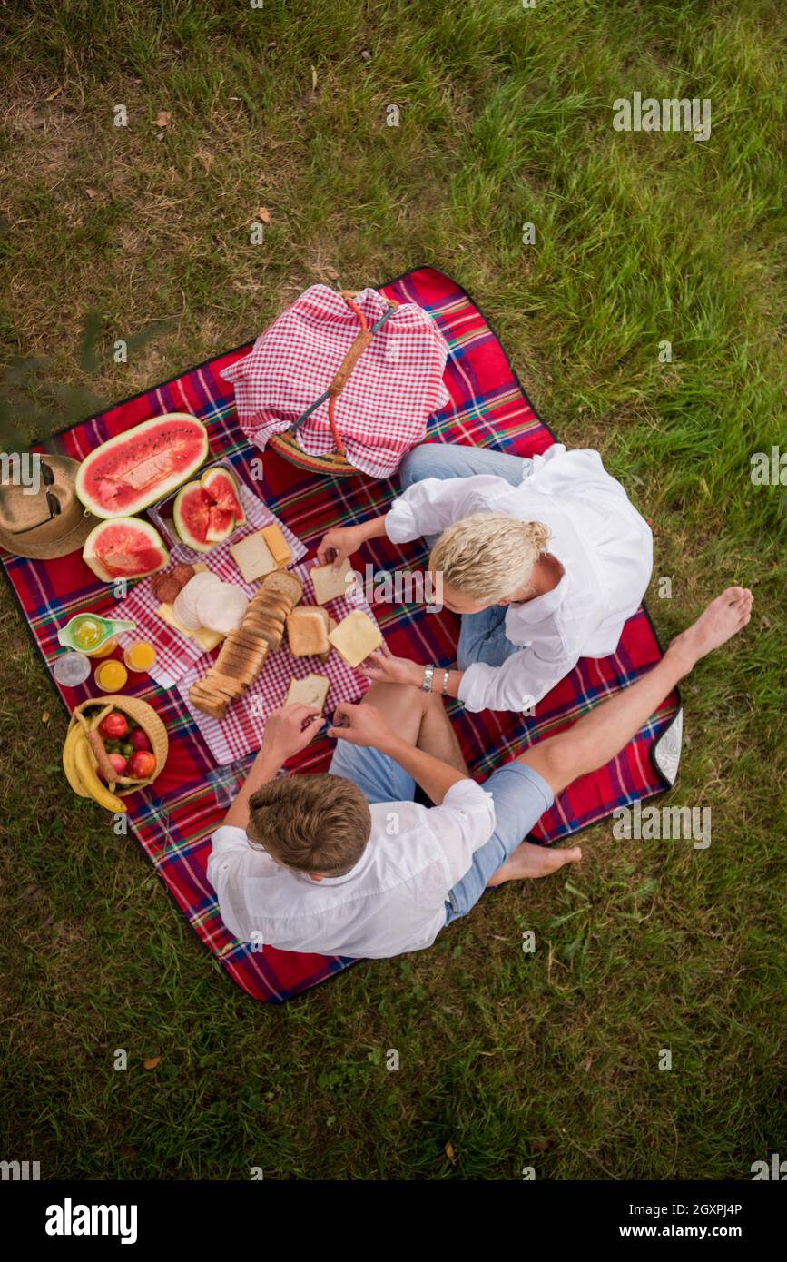 Couple in love enjoying picnic time drink and food in beautiful nature ...