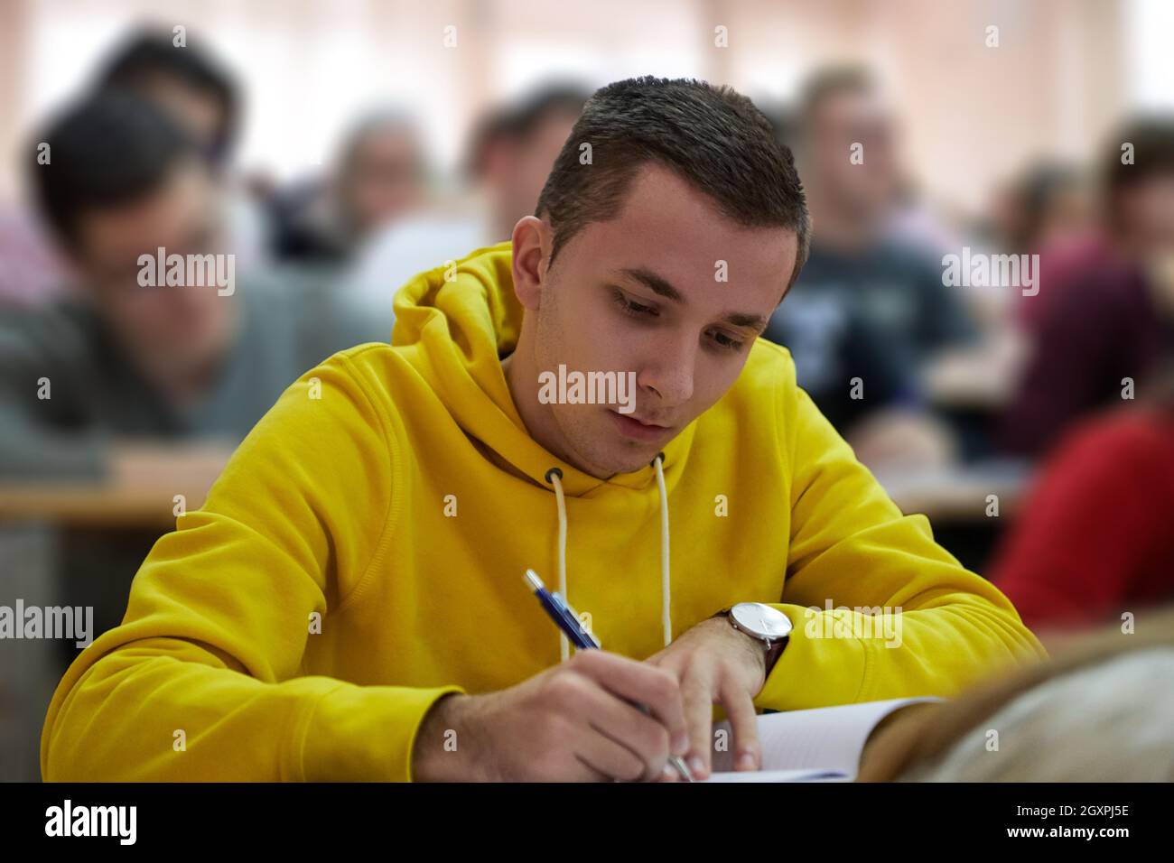 student taking notes while studying in high school. Portrait of college ...