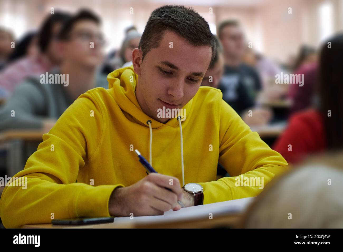 student taking notes while studying in high school. Portrait of college ...