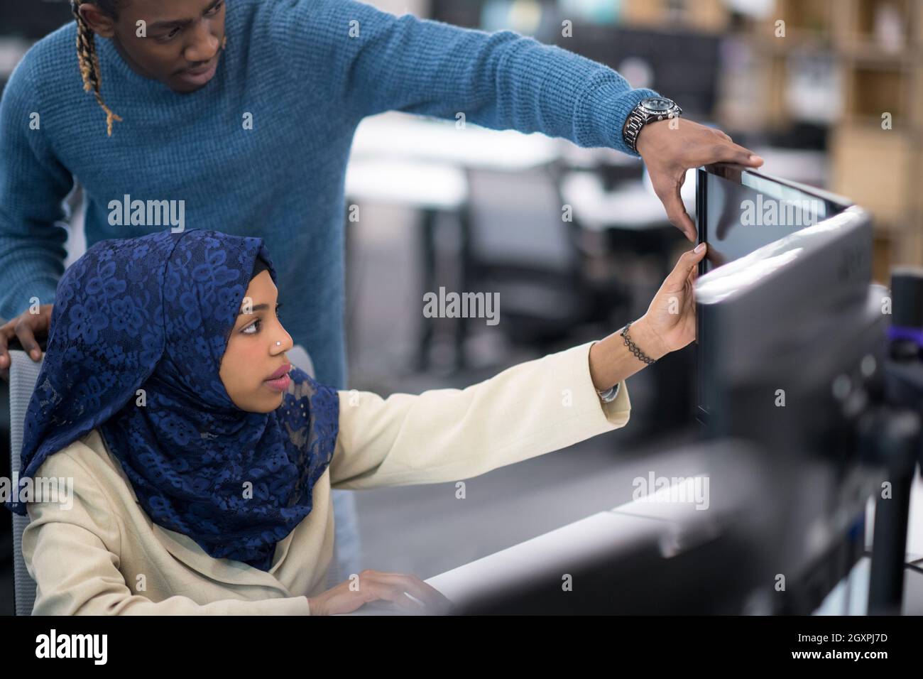 black muslim female software developer working together with her ...