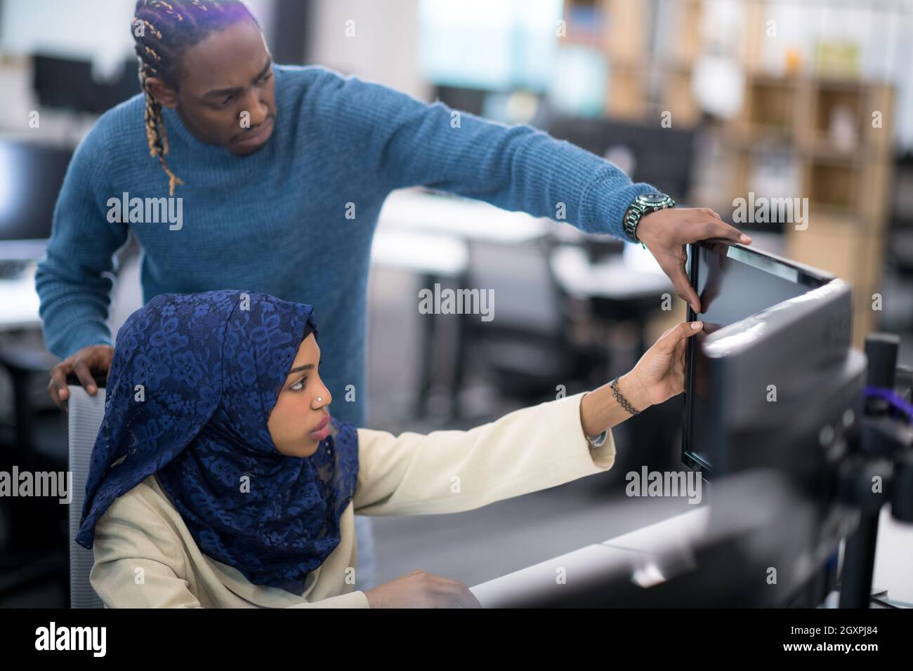 black muslim female software developer working together with her ...
