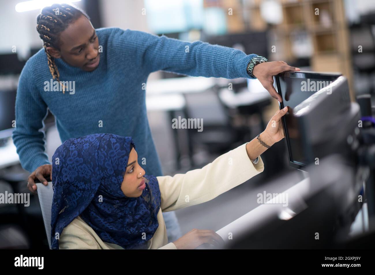black muslim female software developer working together with her ...
