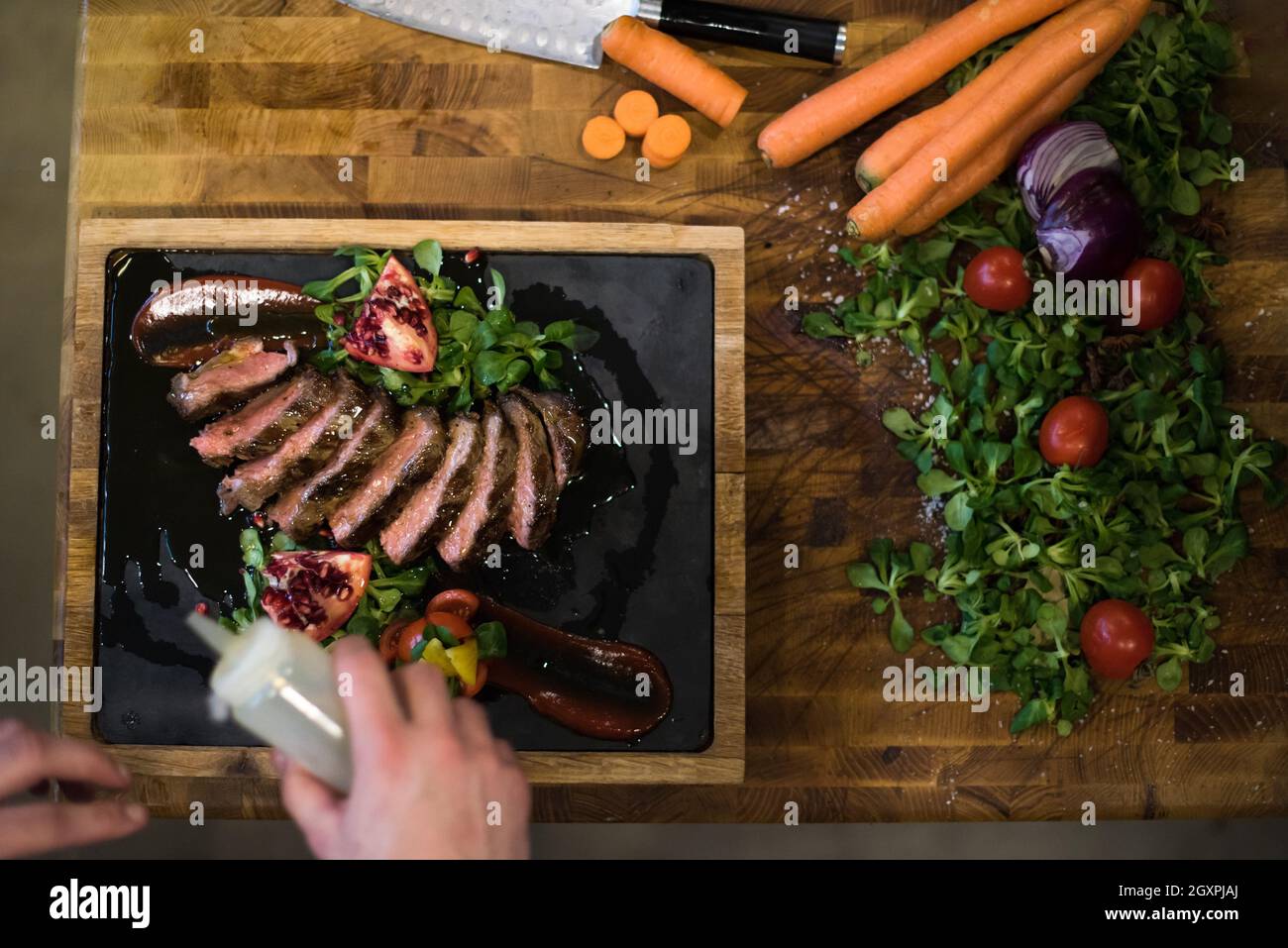 Chef finishing steak meat plate with Finally dish dressing and almost ...