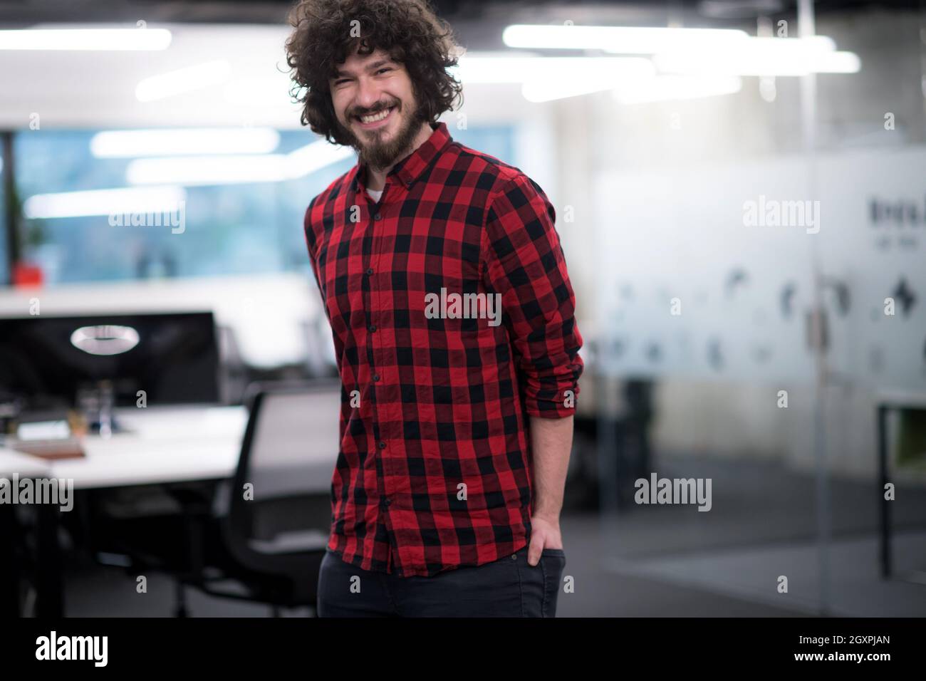 Portrait of young smiling successful male software developer standing ...
