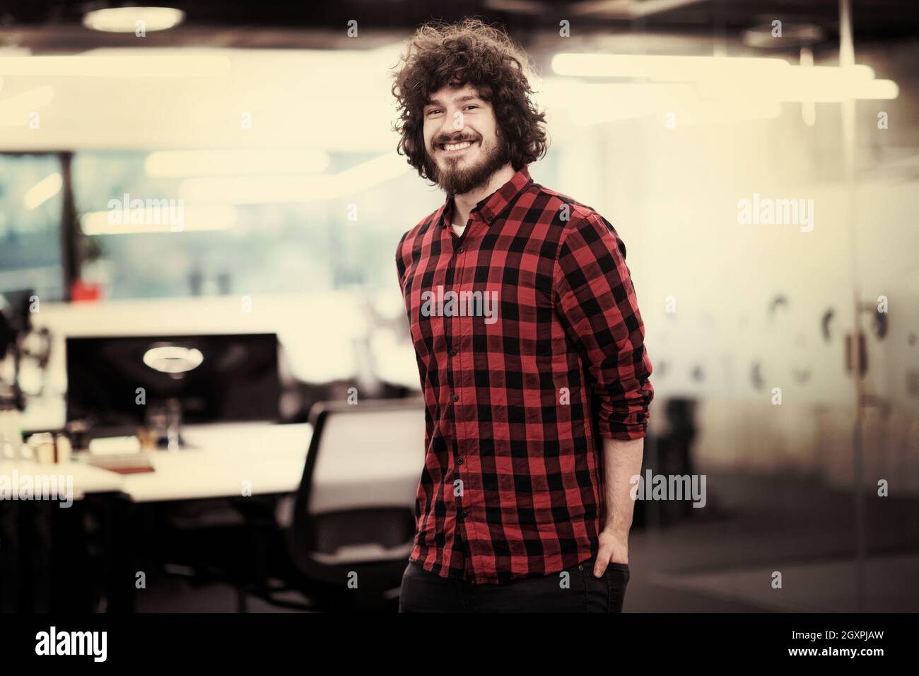 Portrait of young smiling successful male software developer standing ...