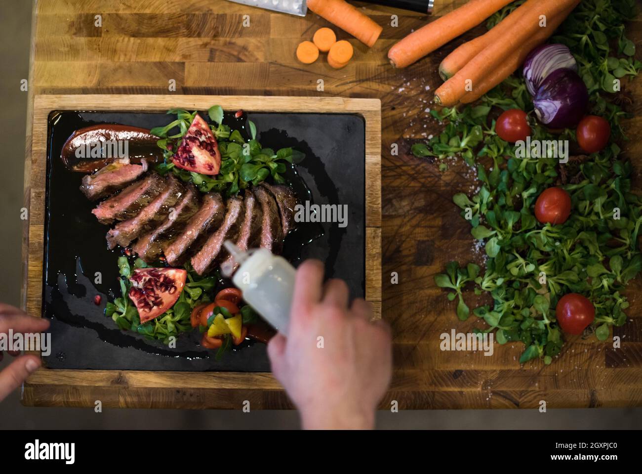 Chef finishing steak meat plate with Finally dish dressing and almost ...