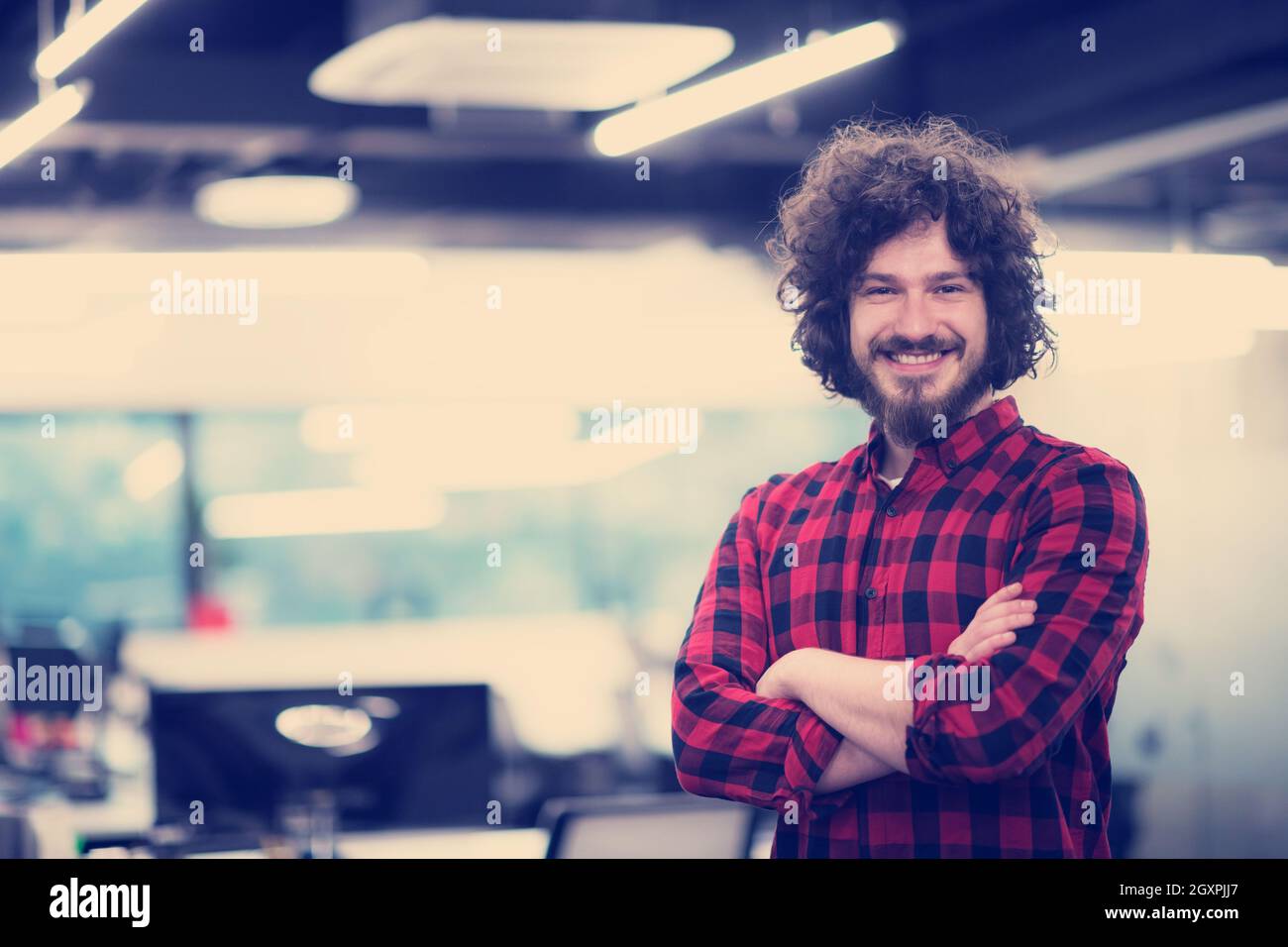 Portrait of young smiling successful male software developer standing ...