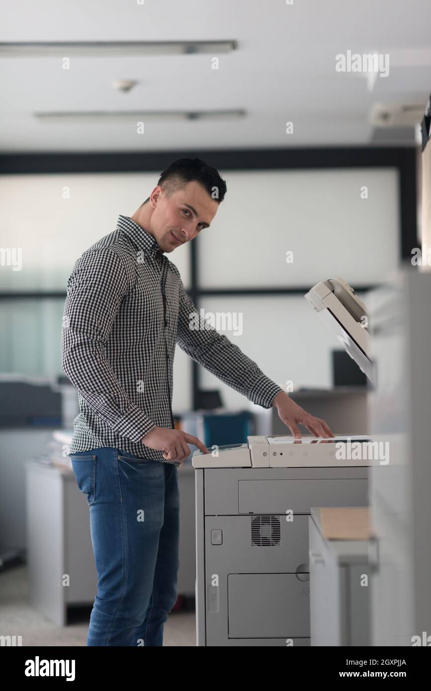 young business man copy documents on copy machine at modern startup ...