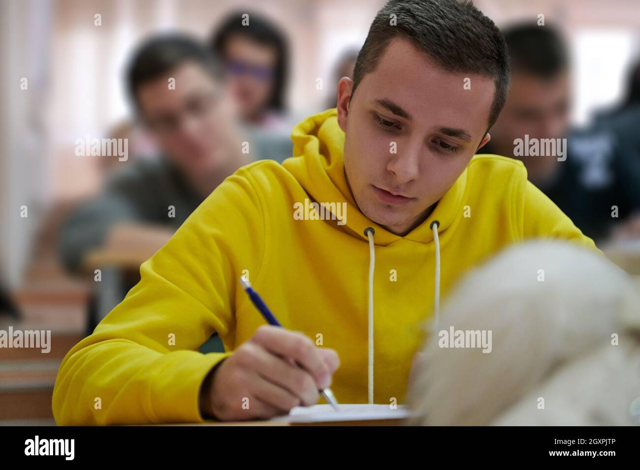 student taking notes while studying in high school. Portrait of college ...