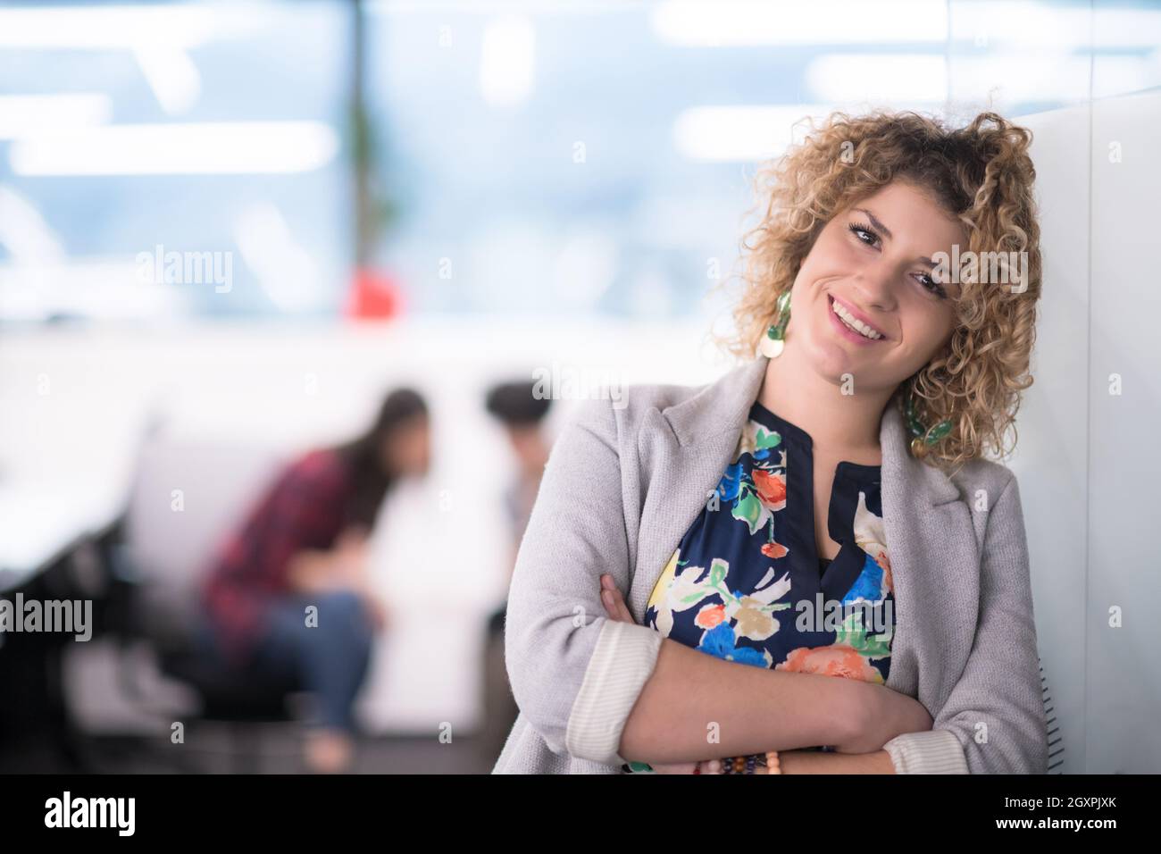 Portrait of successful female software developer with a curly hairstyle ...